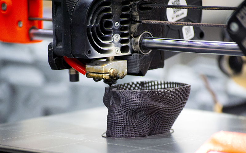 3D printer printing prototype of human skull from molten plastic ...